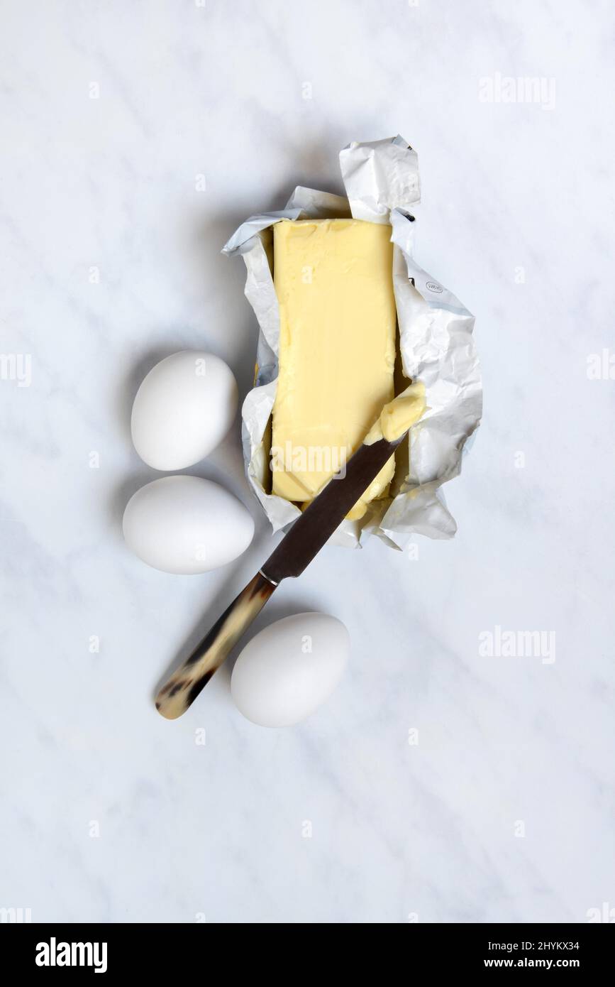 Butter in opened packaging and eggs Stock Photo - Alamy