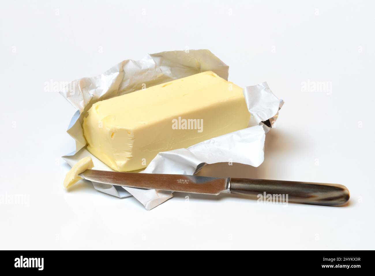 Butter with opened package and knife Stock Photo - Alamy