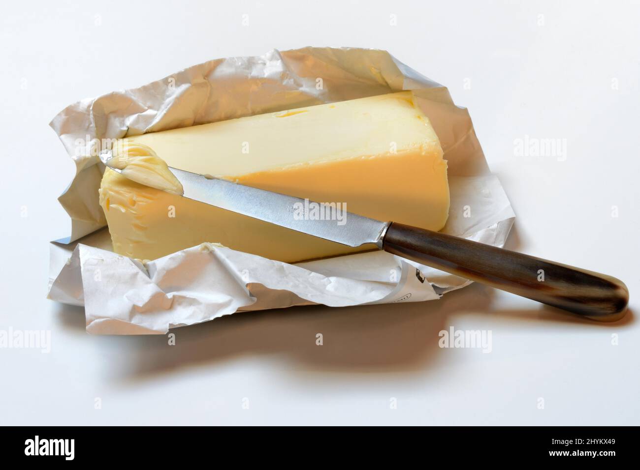 Butter with opened package and knife Stock Photo - Alamy