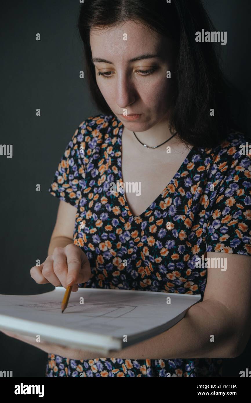 armenian woman artist drawing picture on a gray background Stock Photo ...