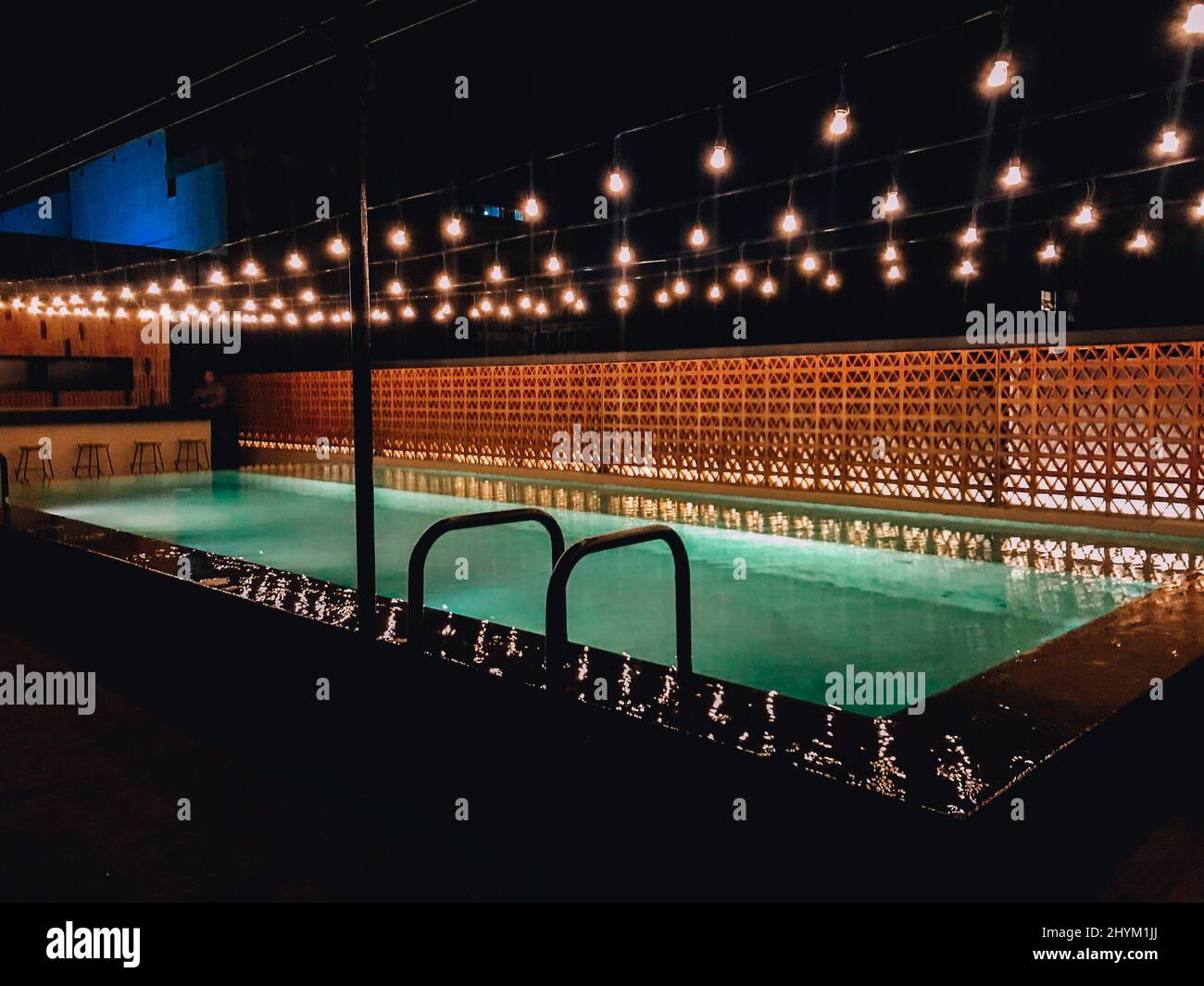 Lights over a swimming pool at night Stock Photo - Alamy