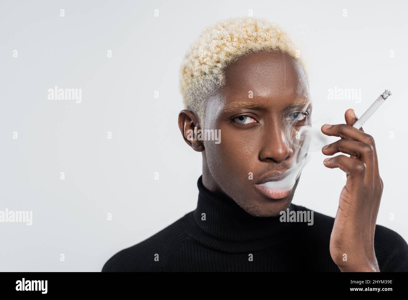blonde african american man with blue eyes smoking cigarette isolated ...
