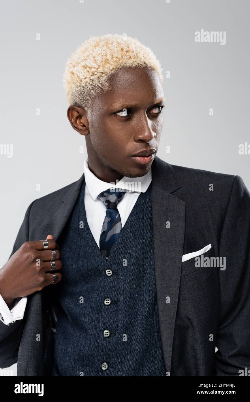 elegant african american man in formal wear looking away isolated on ...