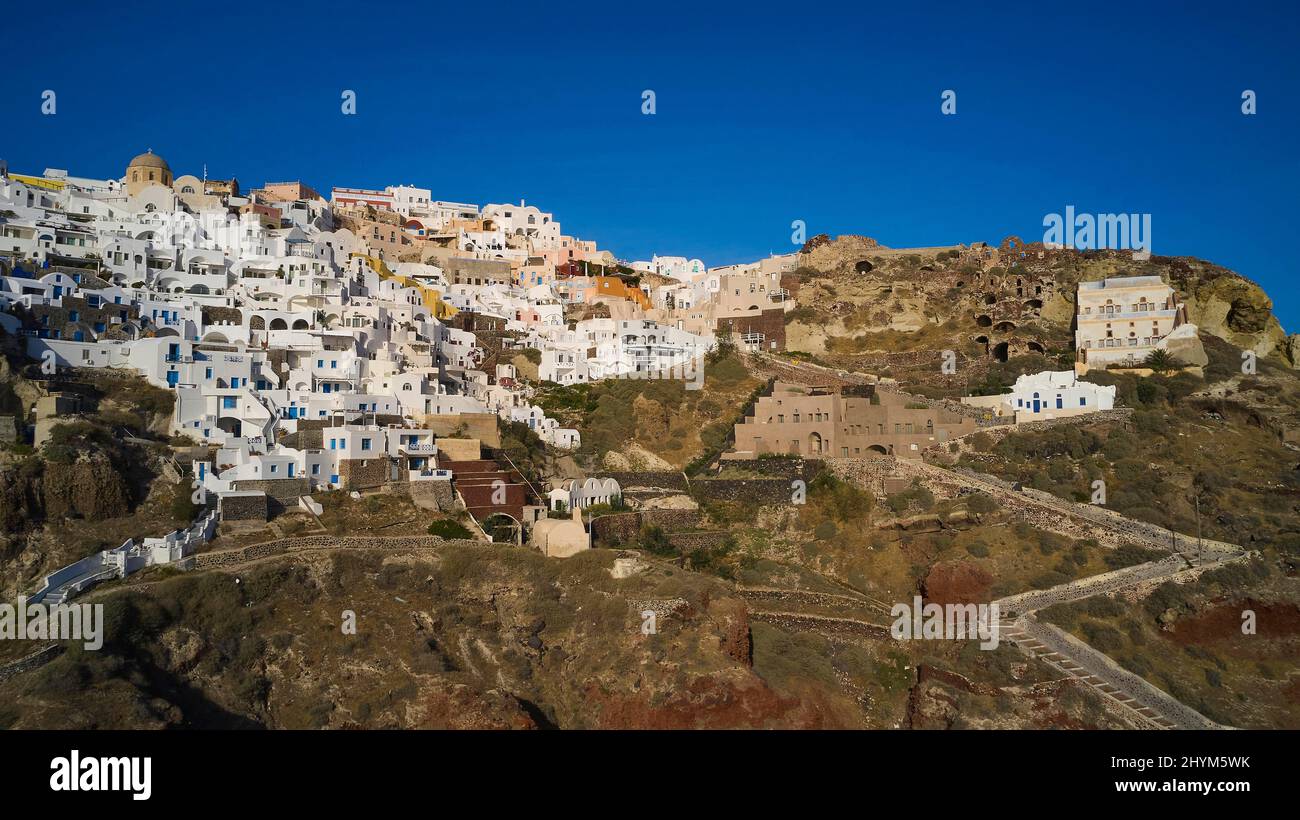 Drone shot, evening light, sea of houses on the hillside, castle, path ...