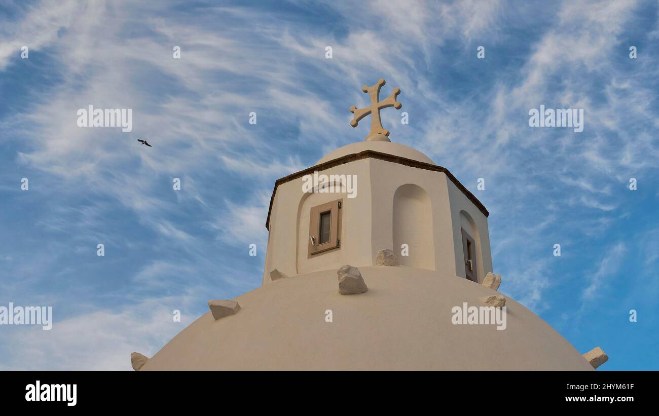 Morning light, white dome of a church, sky blue with veil clouds, Fira ...