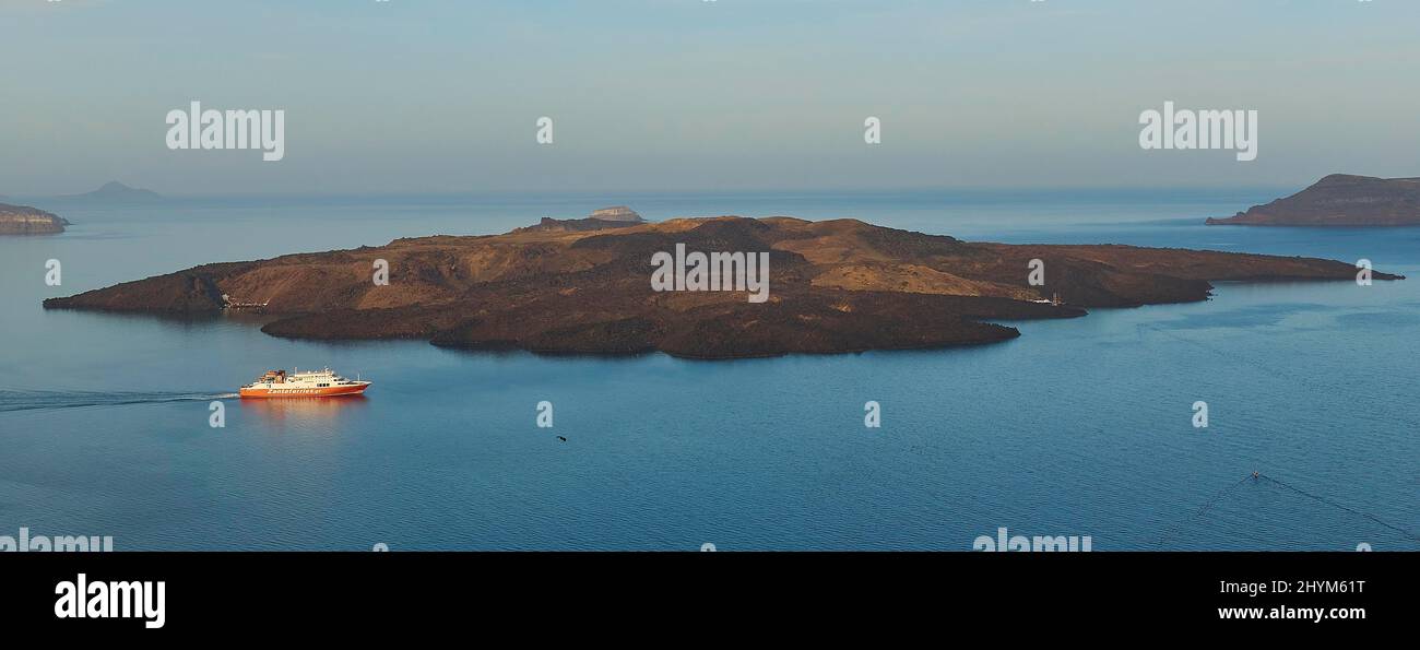 Morning light, volcanic island of Nea Kameni, ferry red and white ...