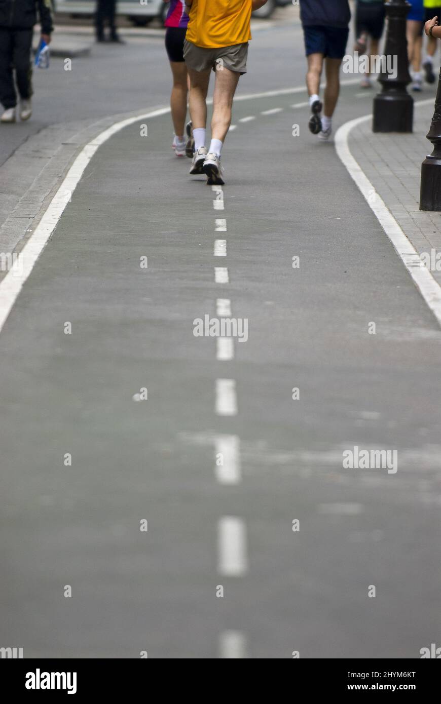 Vertical shot of the multiple male and female athletes running during ...
