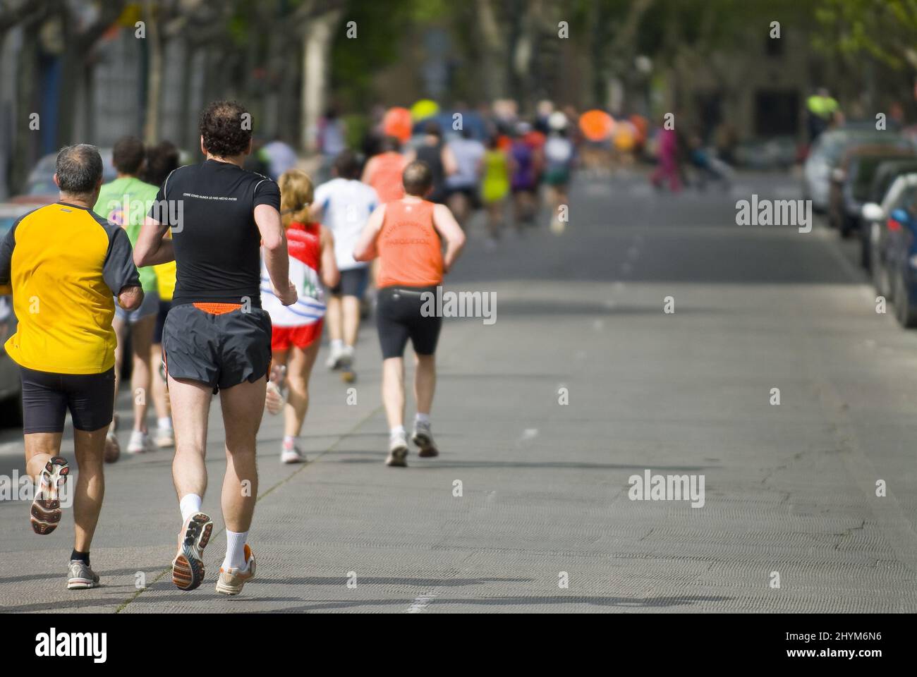 Shot of the multiple male and female athletes running during the ...