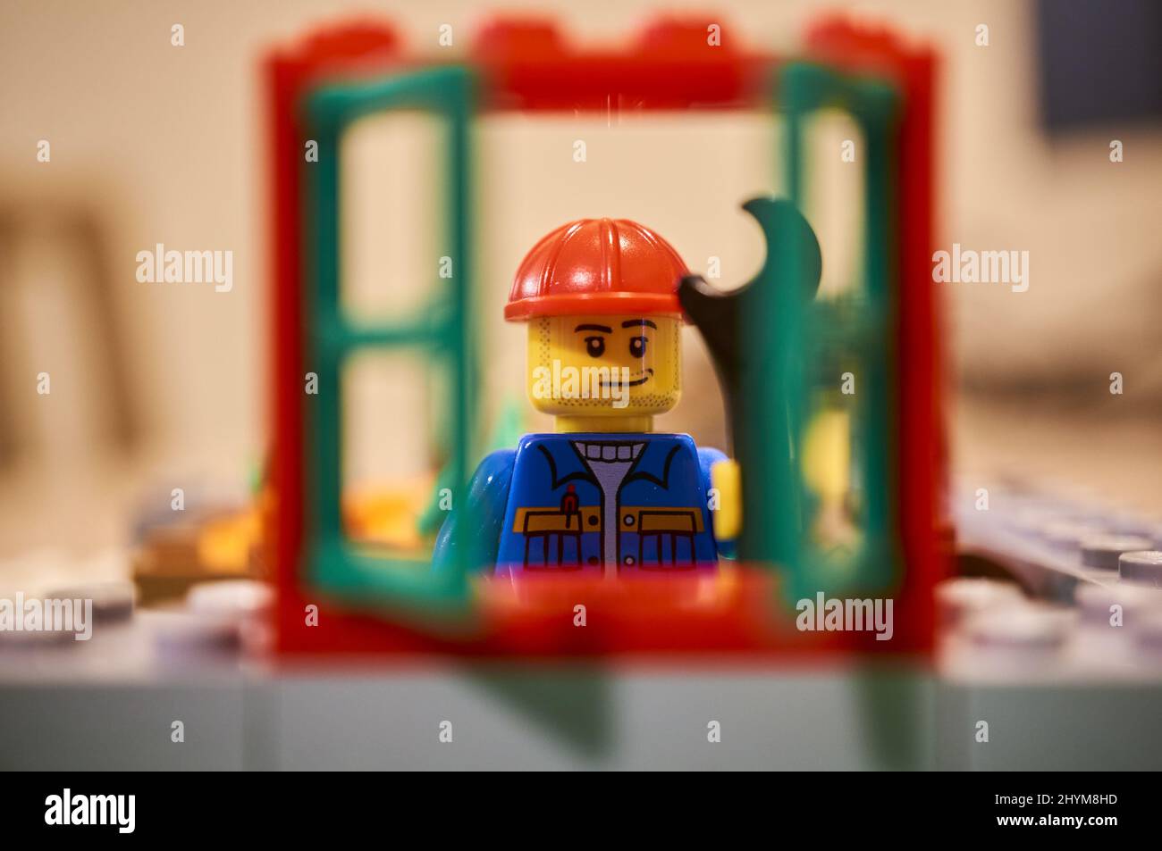 Selective focus of a Lego construction worker toy looking through a ...