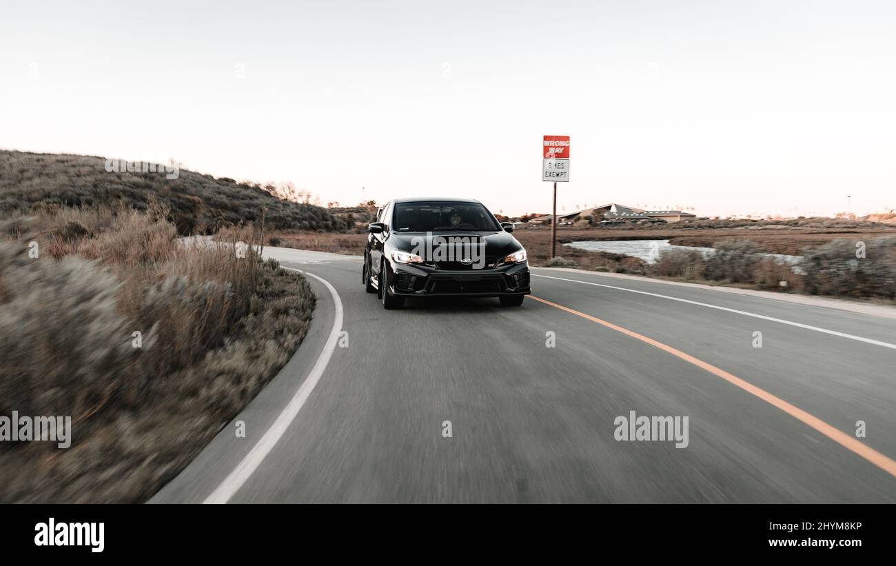 Modern black Subaru car driving in a highway of Newport Beach ...