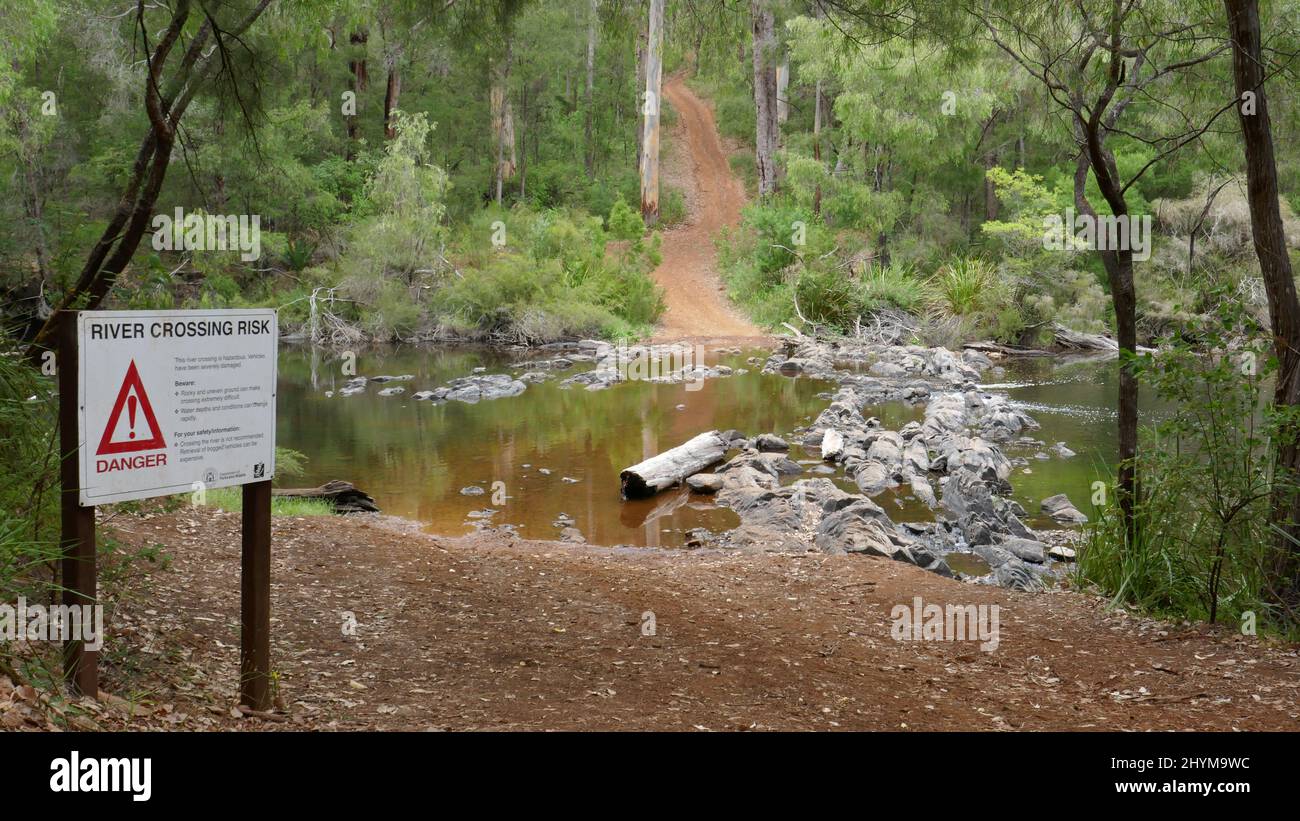 Dangerous river crossing sign at a 4WD crossing point Stock Photo - Alamy