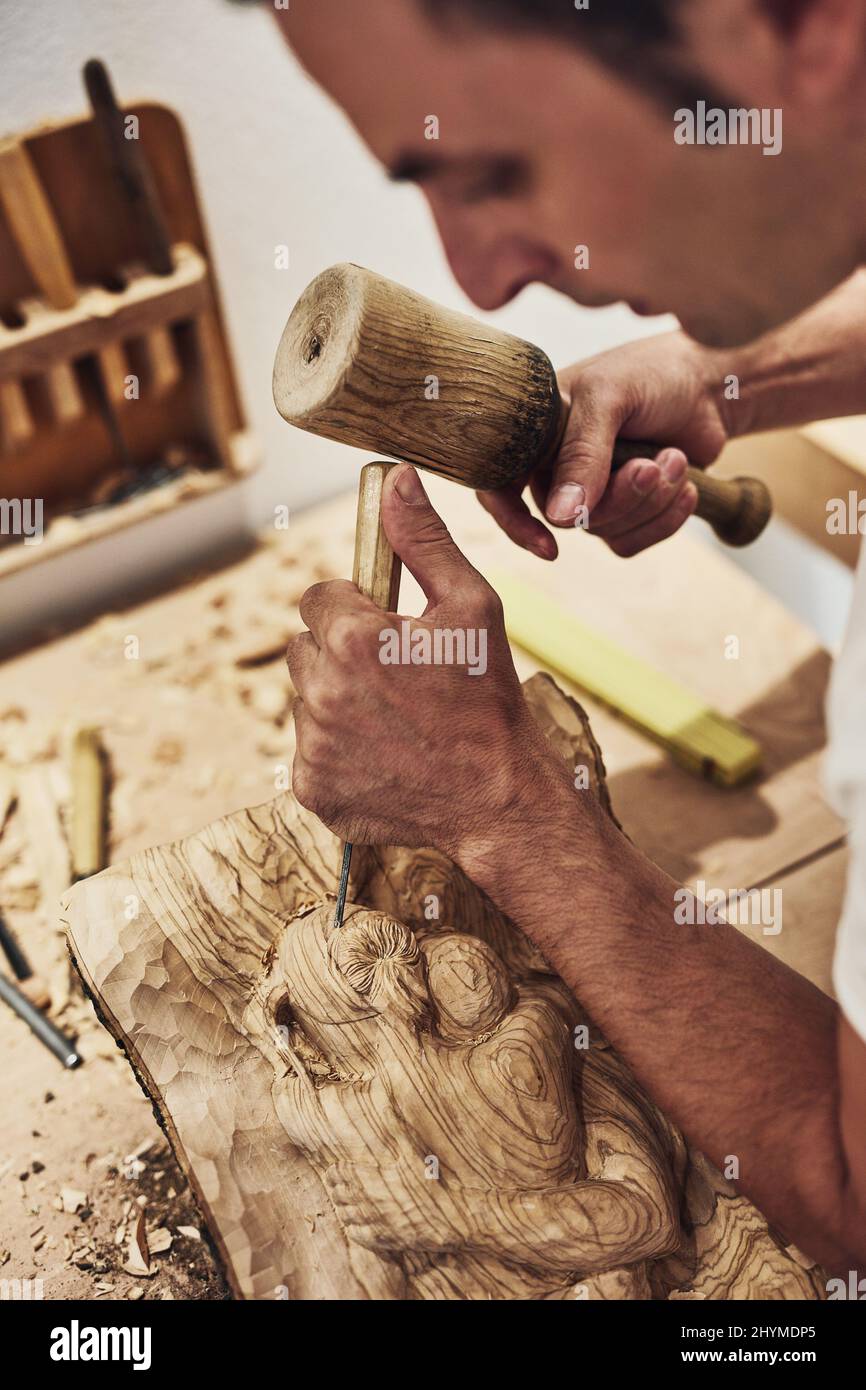 Making something meaningful. Cropped shot of an artist carving ...