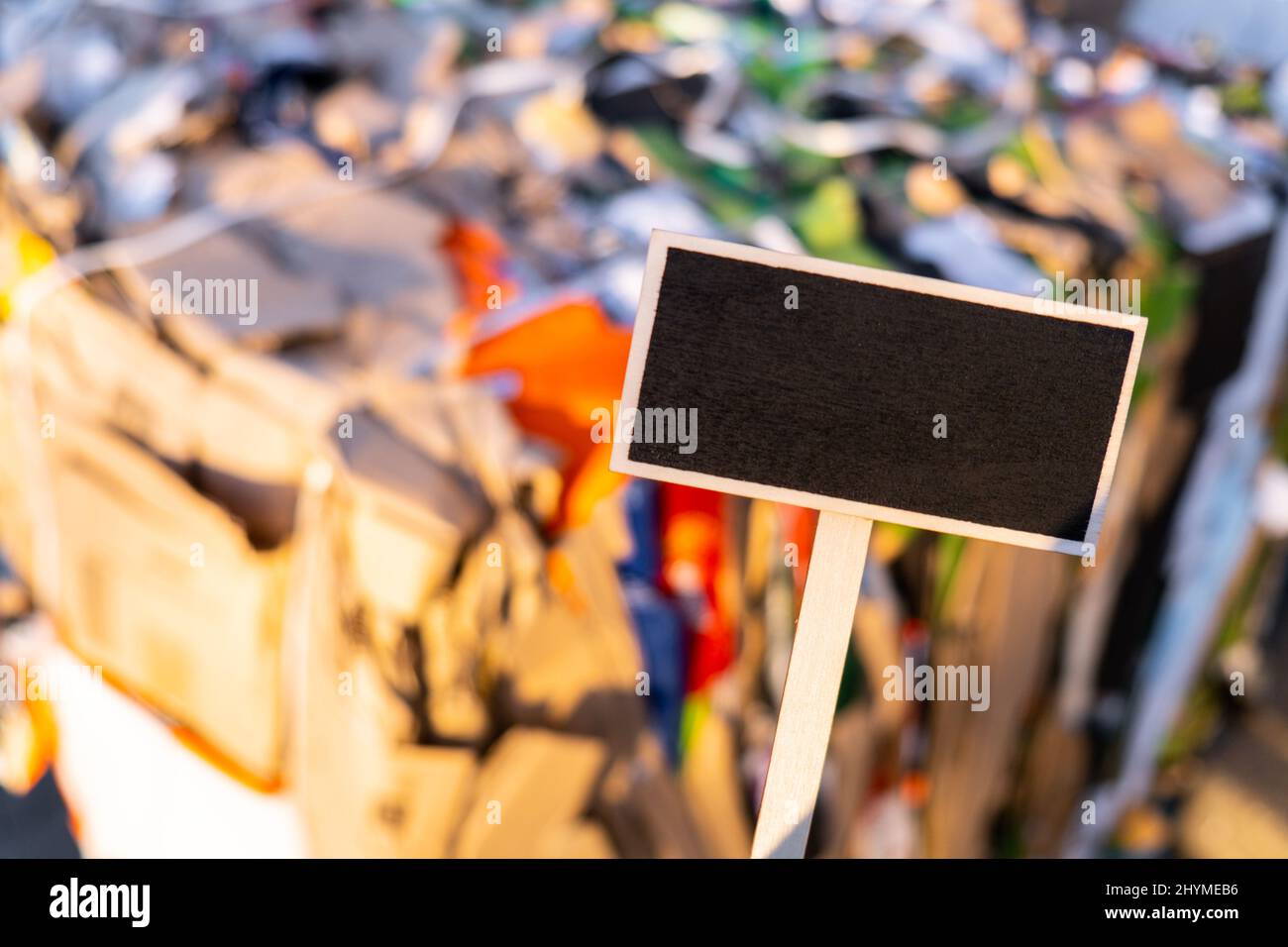 Wooden information label sign with black chalkboard against defocused ...