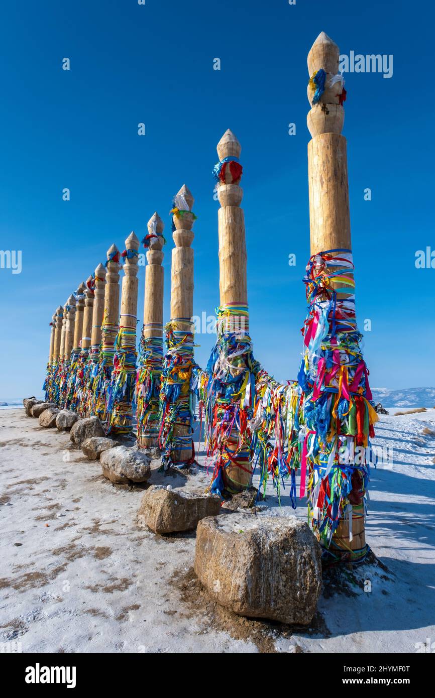 Wooden ritual pillars with color ribbons Stock Photo - Alamy
