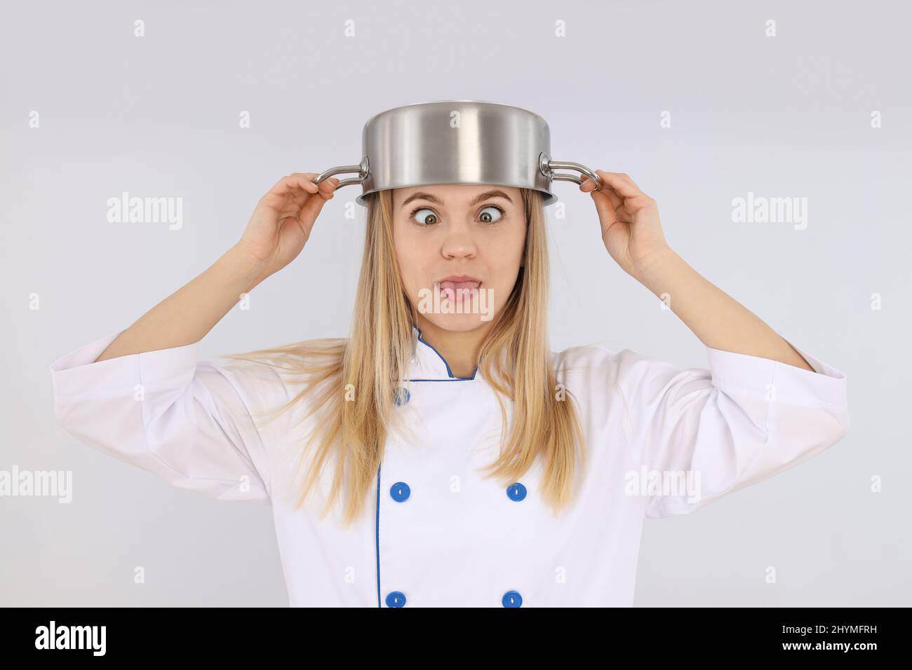 Funny young chef woman on light background Stock Photo - Alamy