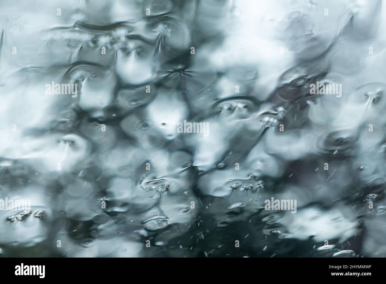 Closeup of the crystal clear rain droplets on the transparent glass ...