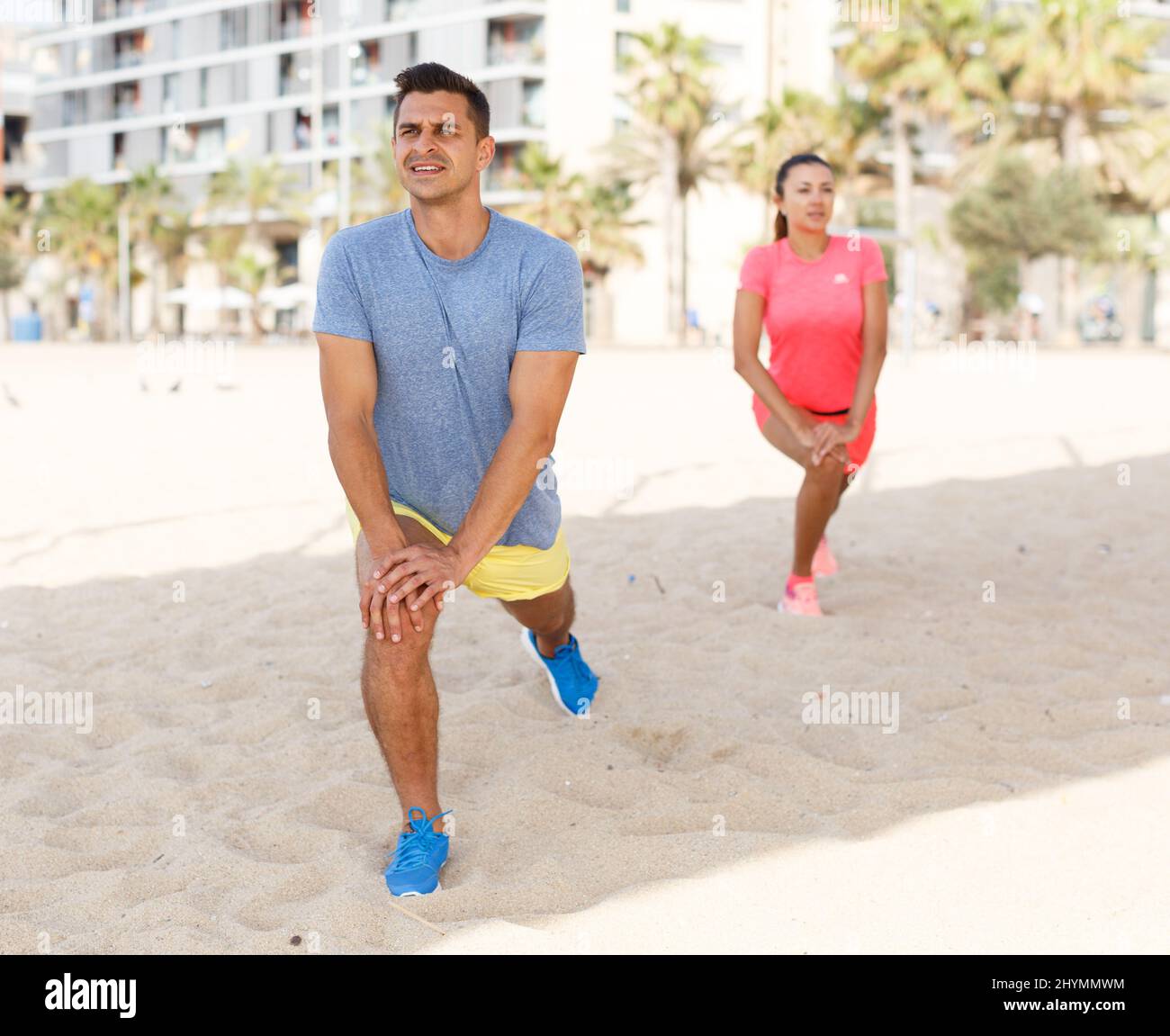 Healthy fitness friends doing exercises during morning workout at ...