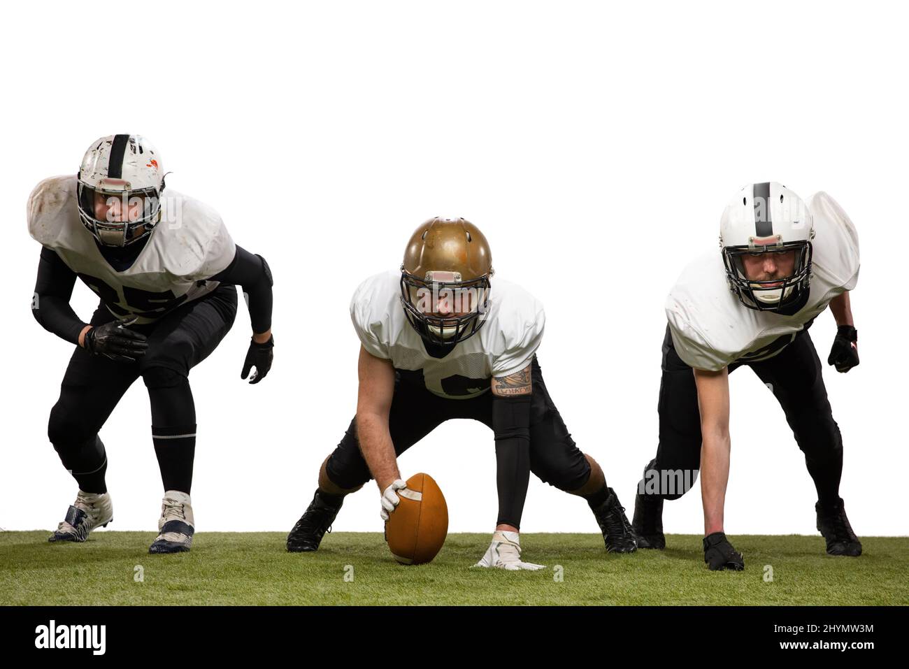 Three young sportive men, professional american football players in ...