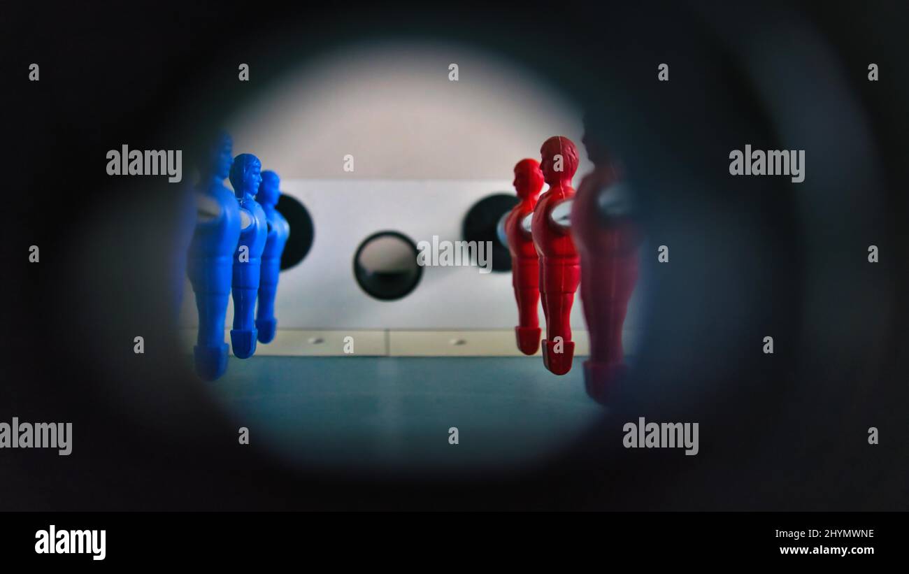 View through the throw-in hole, red and blue players of a foosball ...
