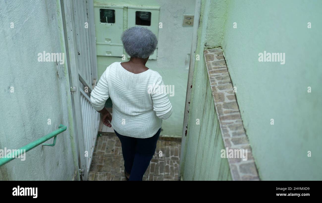 A senior black woman leaving house person opening front door Stock ...
