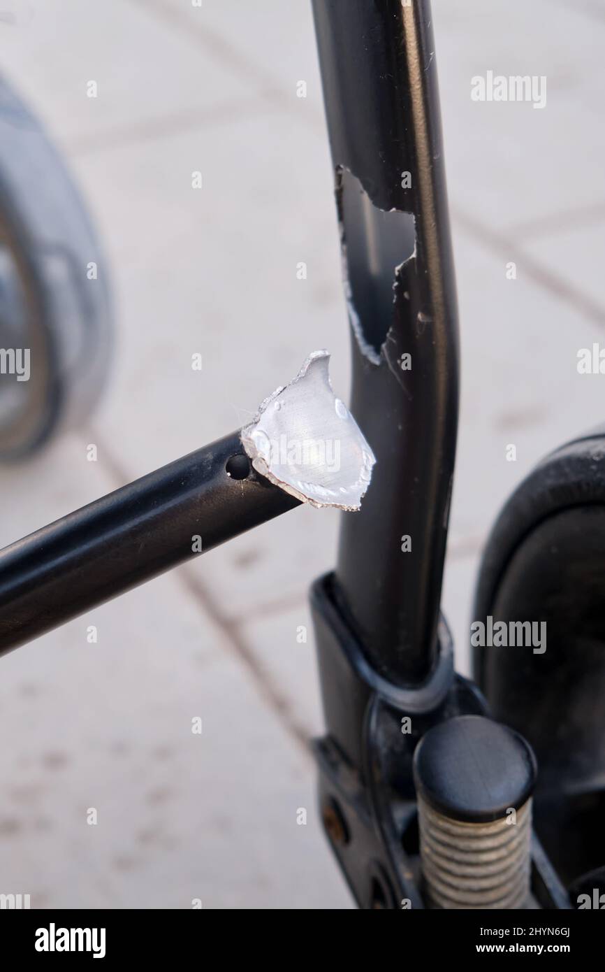 Broken chassis of a baby stroller, damage to the crossbar of the metal ...