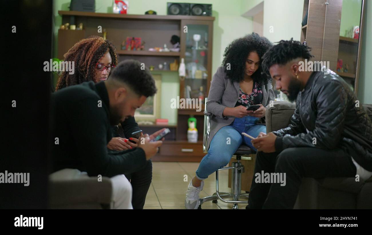Candid group of friends staring at phones living in isolation bubbles ...