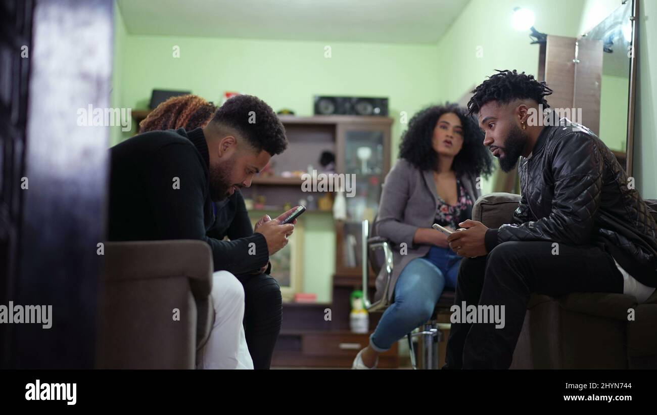 Candid group of friends staring at phones living in isolation bubbles ...