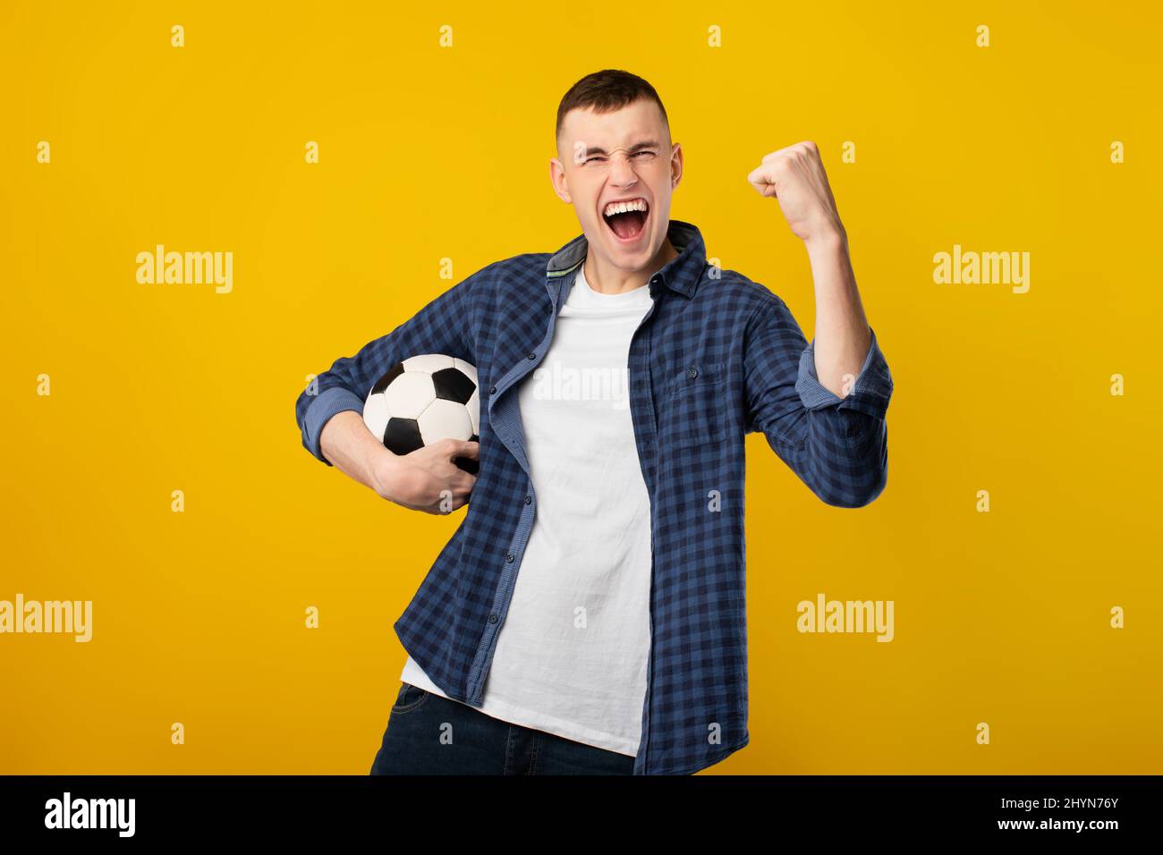 Soccer Fan Guy Holding Football Ball Gesturing Yes, Yellow Background ...