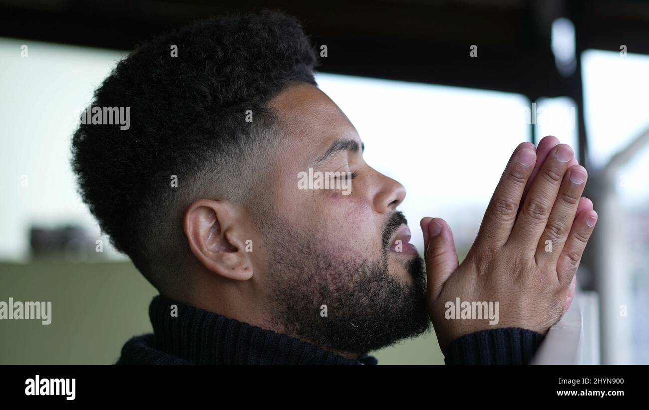 One man praying to God a latin hispanic person prays having HOPE Stock ...