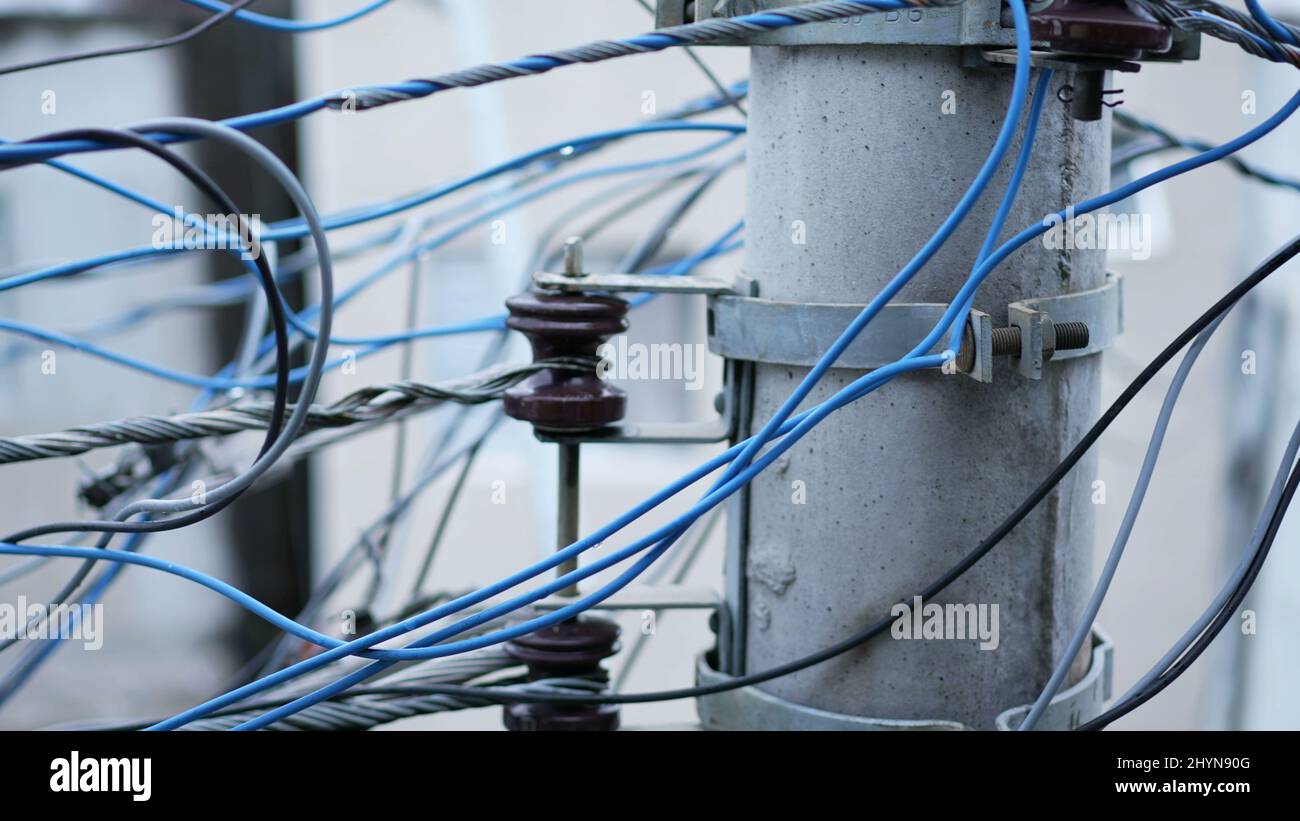 Messy wires from electric poles chaotic mess Stock Photo - Alamy