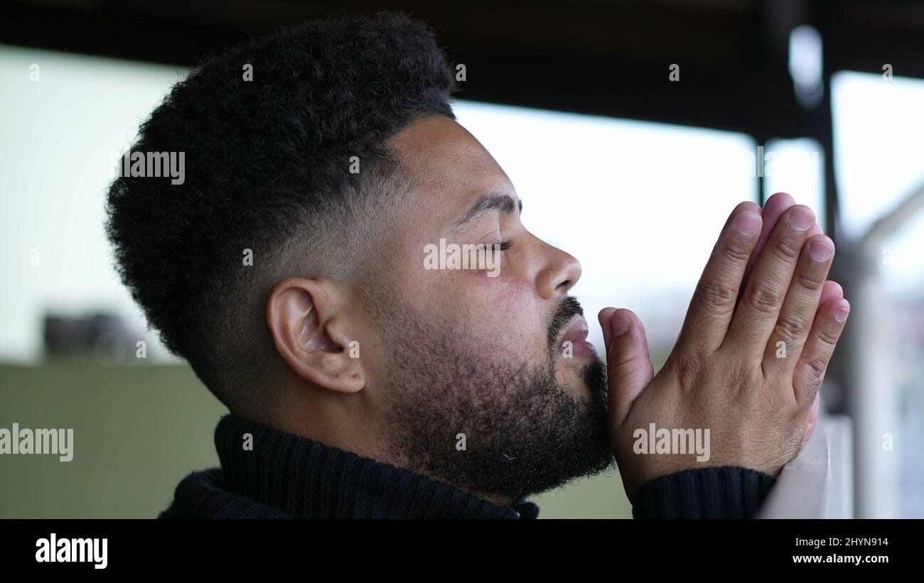 One man praying to God a latin hispanic person prays having HOPE Stock ...