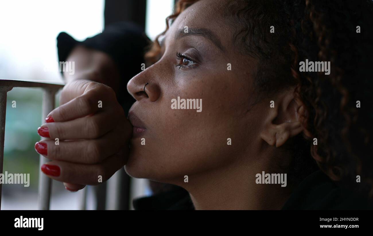 A worried woman face staring at the horizon with a concerned emotion ...