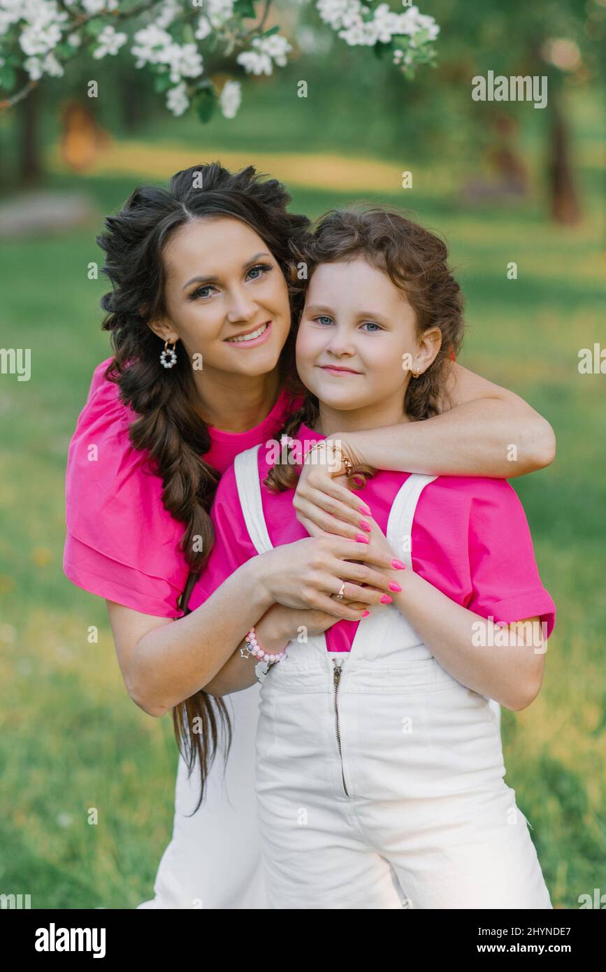 A young beautiful mom is happy and hugs her daughter, who is smiling Stock Photo - Alamy