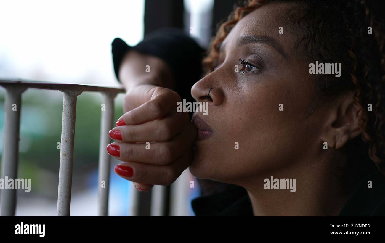 A worried woman face staring at the horizon with a concerned emotion ...