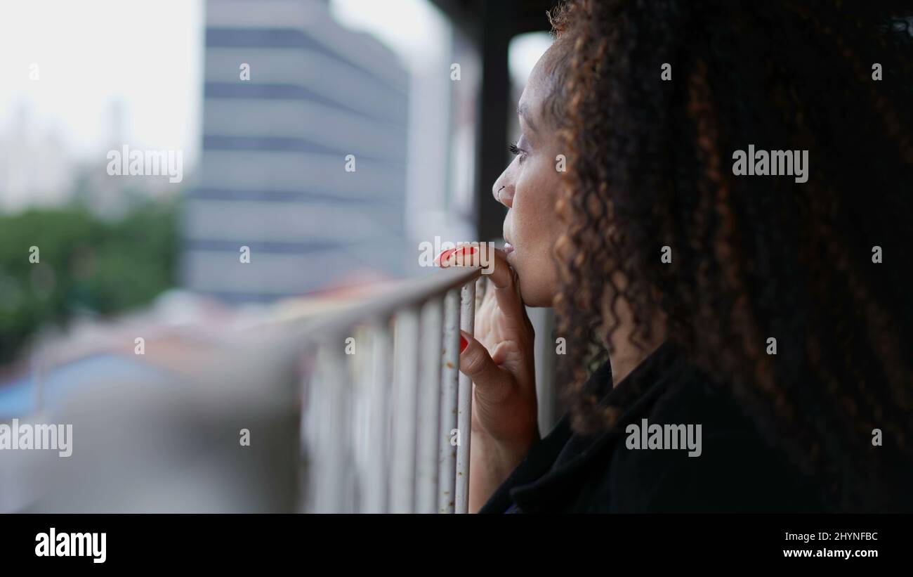 Woman peeking outside from balcony looking out staring out Stock Photo ...