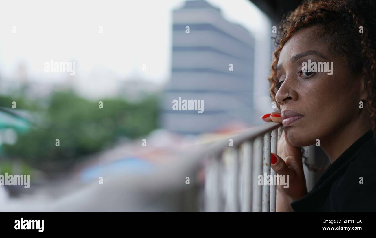 Woman peeking outside from balcony looking out staring out Stock Photo ...