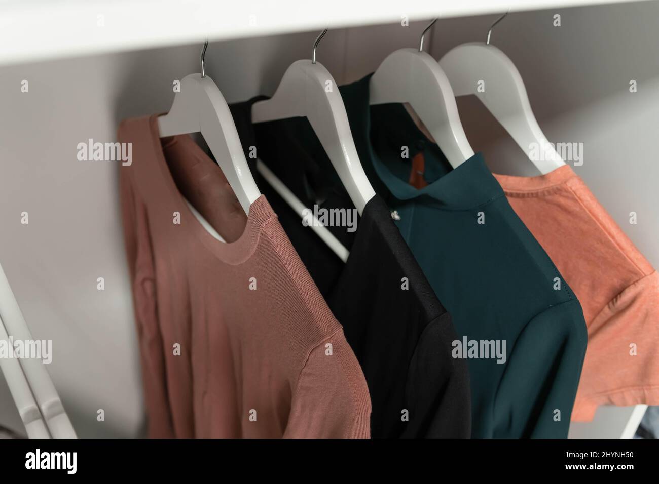 Fashion clothes hang on a hanger. Collection of female clothes hanging ...