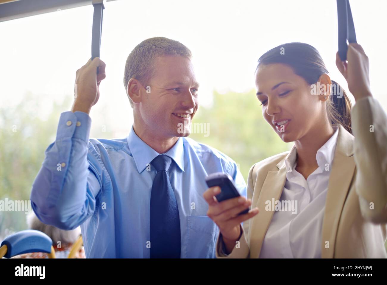 Bonding on the bus. Two young colleagues traveling on the bus and ...