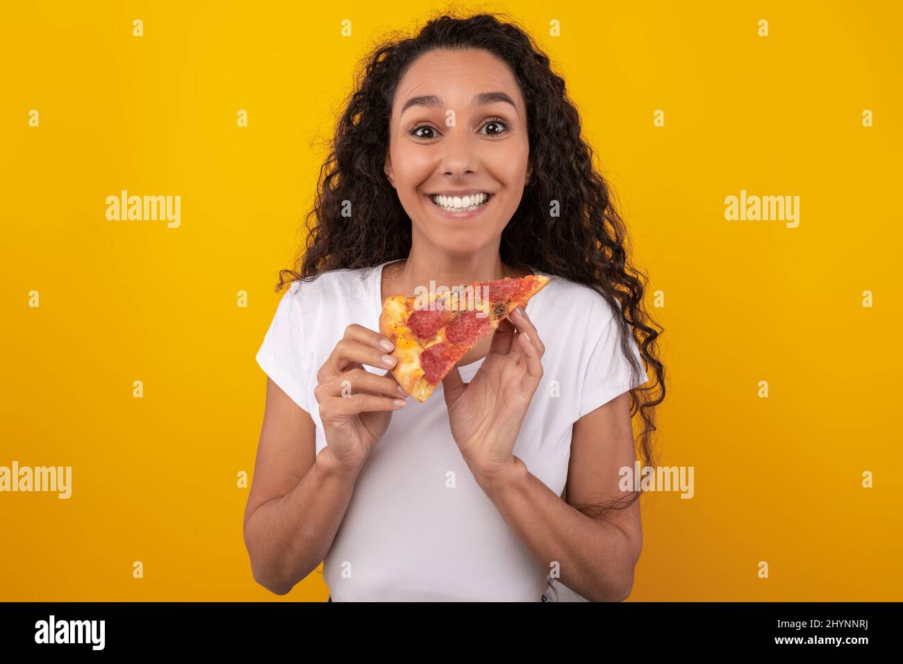 Young woman holding pizza model hi-res stock photography and images - Alamy