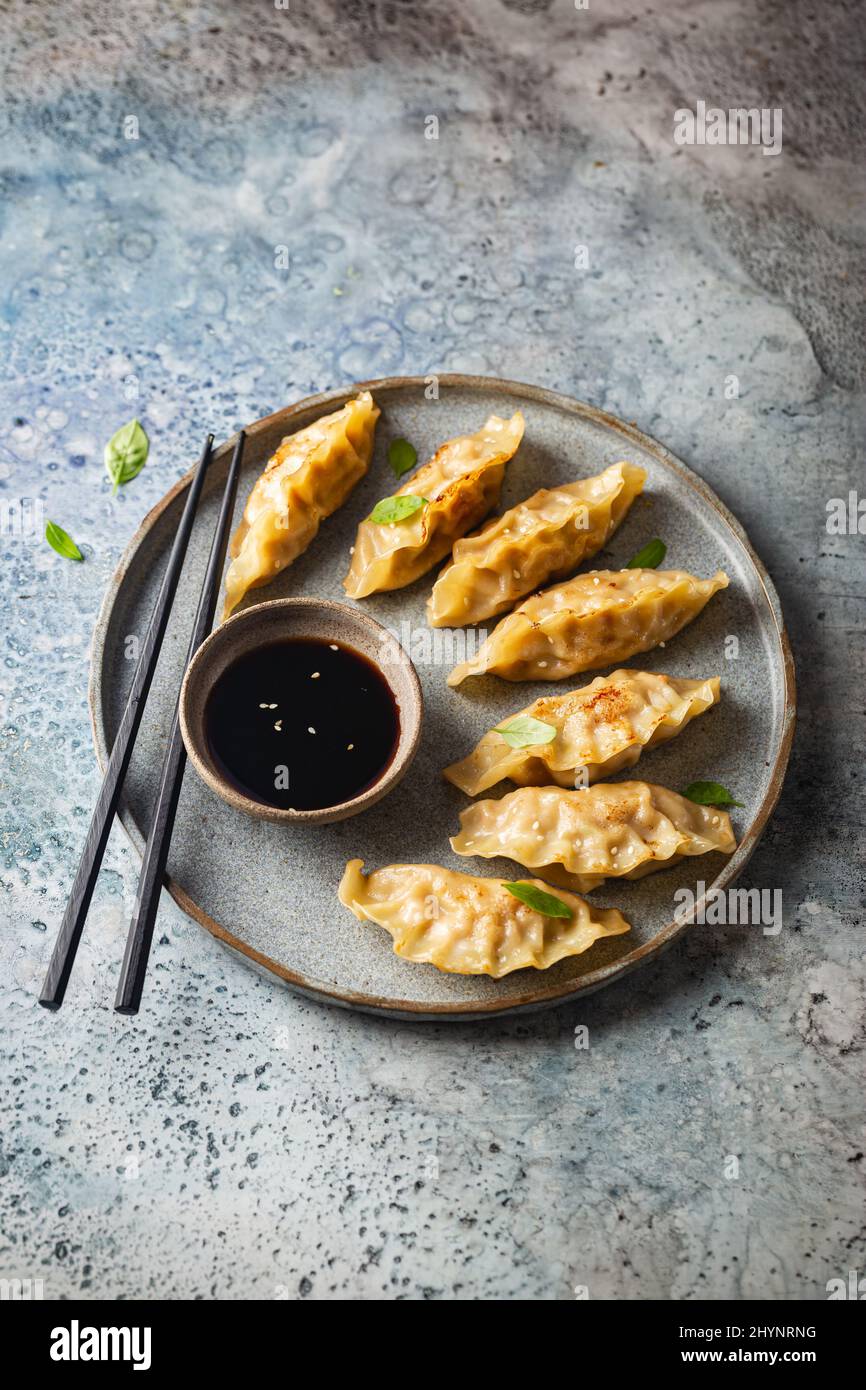 Asian dumplings with soy sauce, sesame seeds and microgreens ...