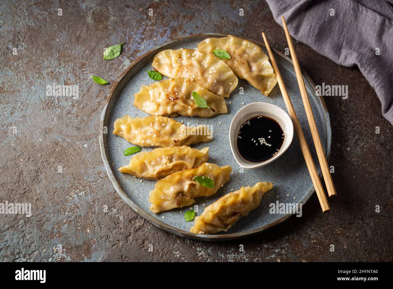 Asian dumplings with soy sauce, sesame seeds and microgreens ...
