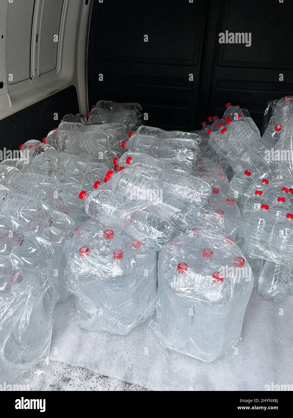 Opened car trunk with packages of water bottles for Ukrainian army ...