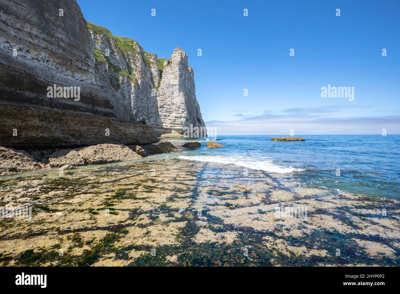 The cliffs and ditches on the beach of Etretat on the Normandy coast ...