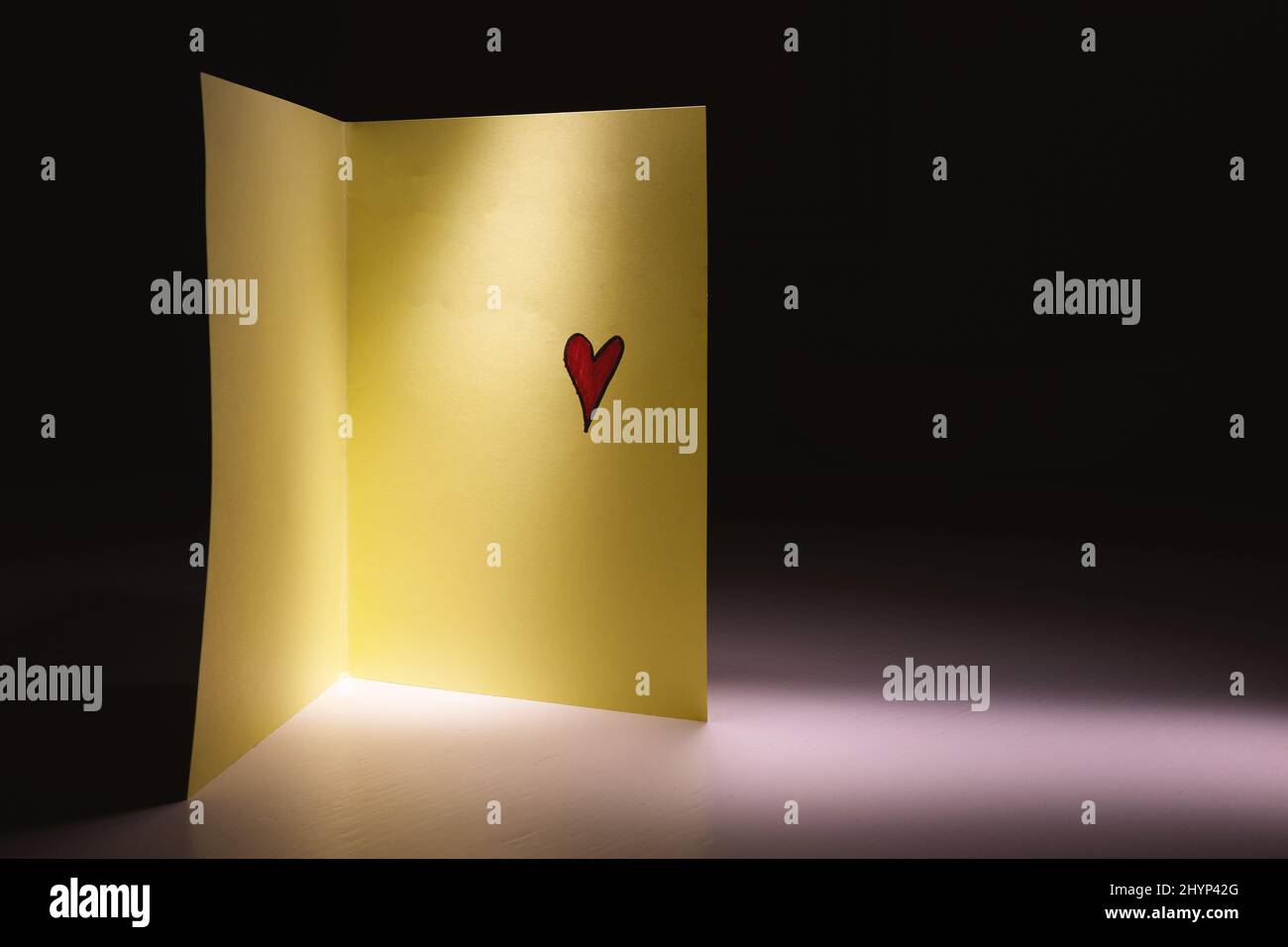 Open gift card with painted red heart on white table Stock Photo - Alamy