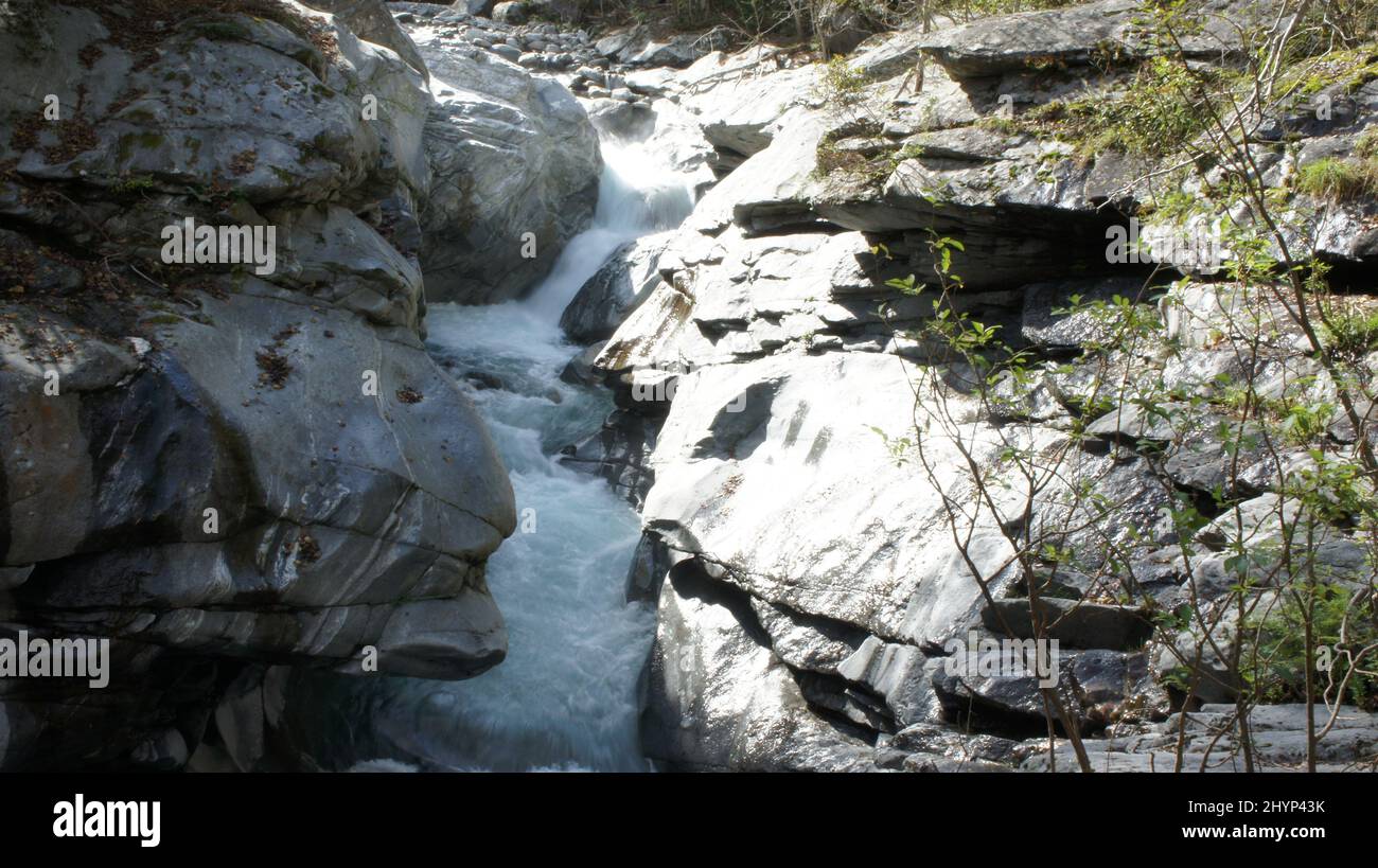 River is flowing between rocks Stock Photo - Alamy