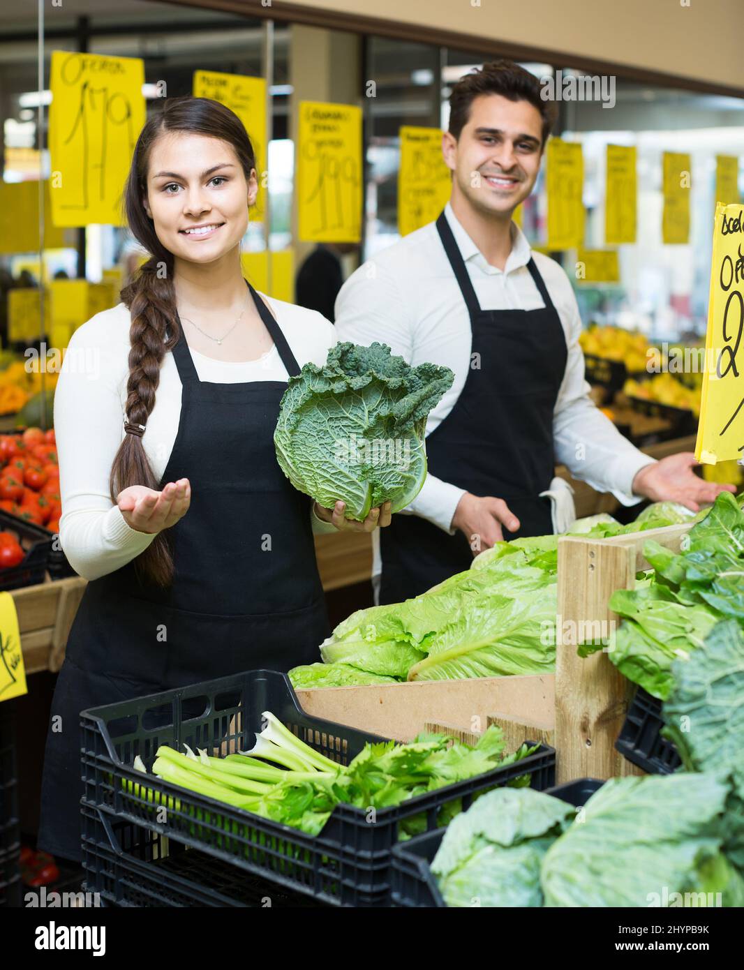 Positive shop people standing near cabbage in grocery Stock Photo - Alamy
