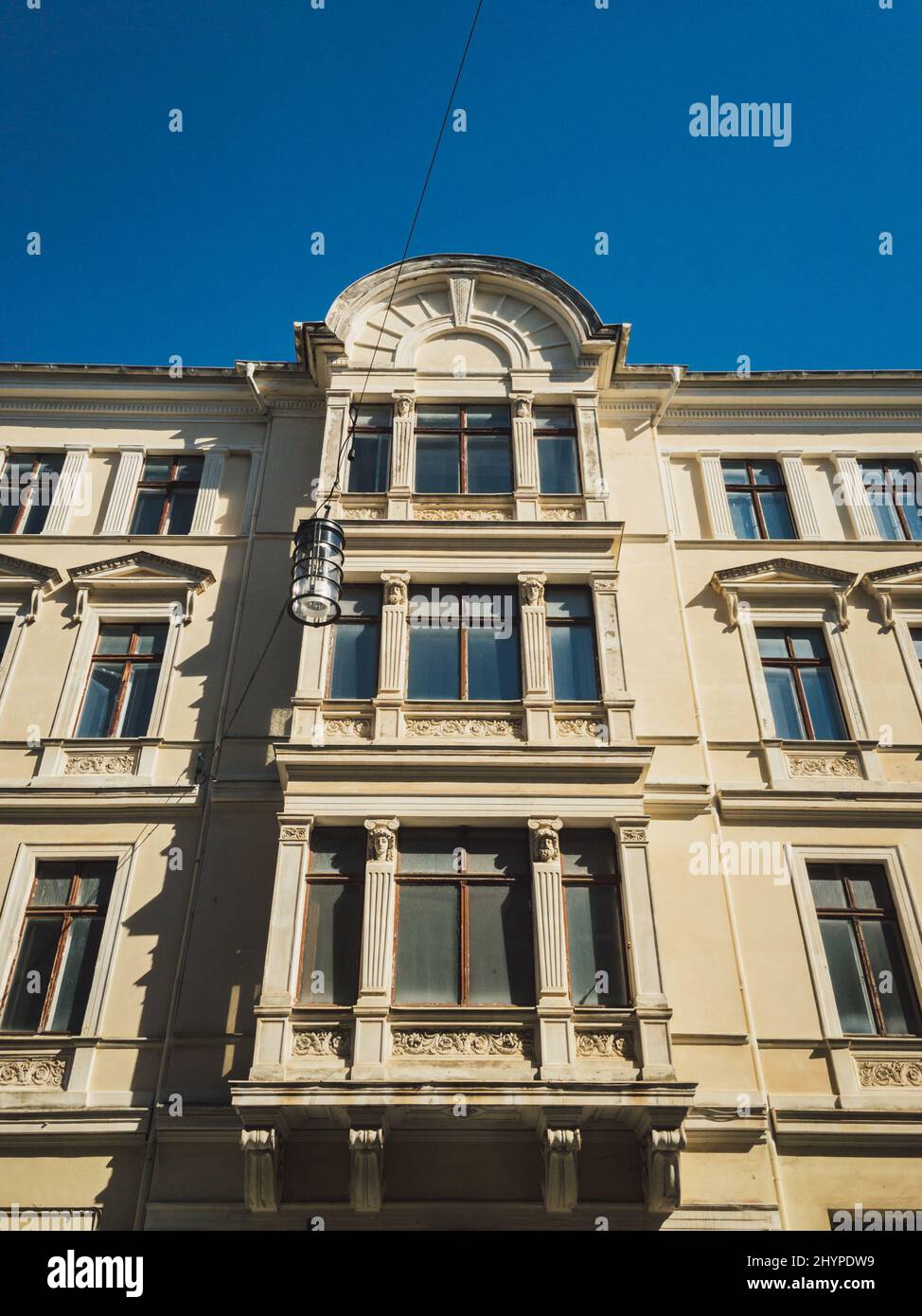 Low angle vertical shot of the facade of an old white building in ...