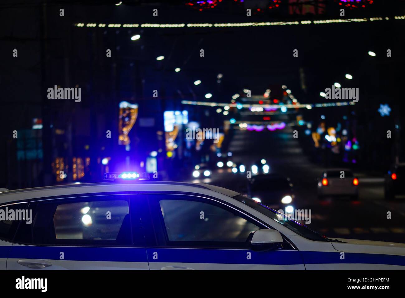 police car with lights in night city, closeup side view with selective ...