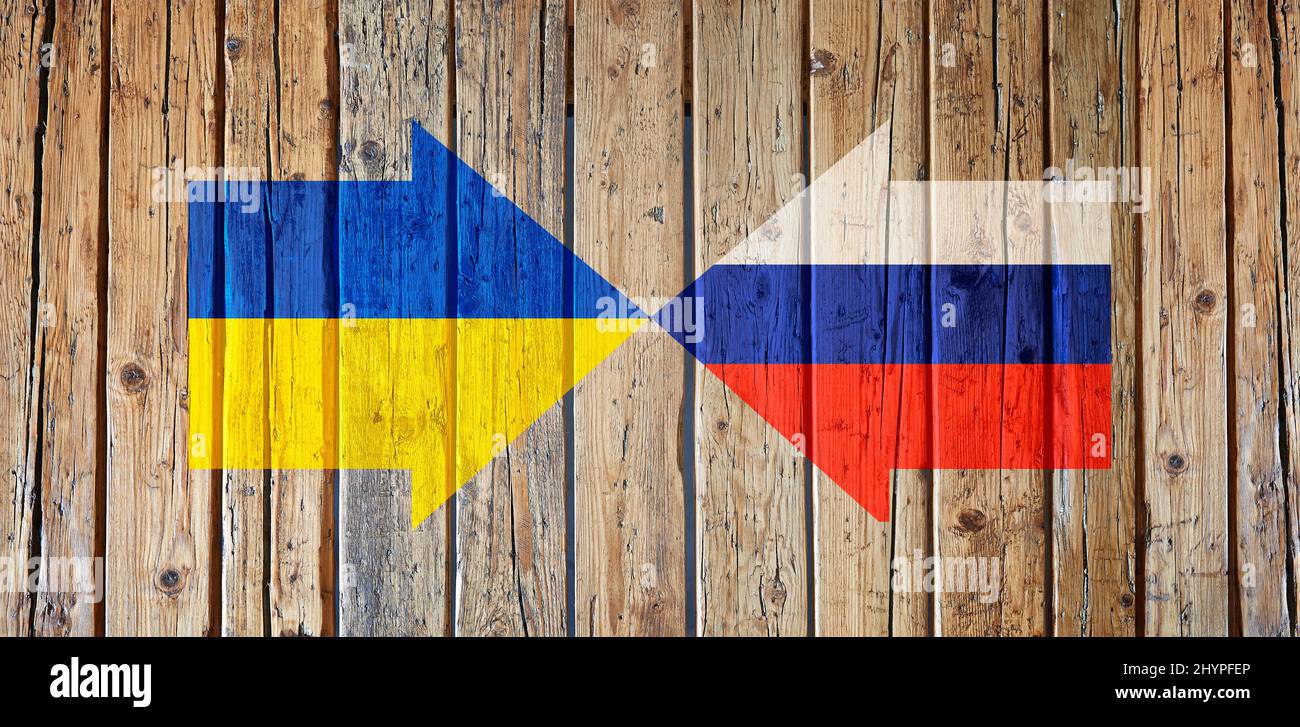 Ukranian rrow vs Russian arrow with flags painting on wooden fence ...