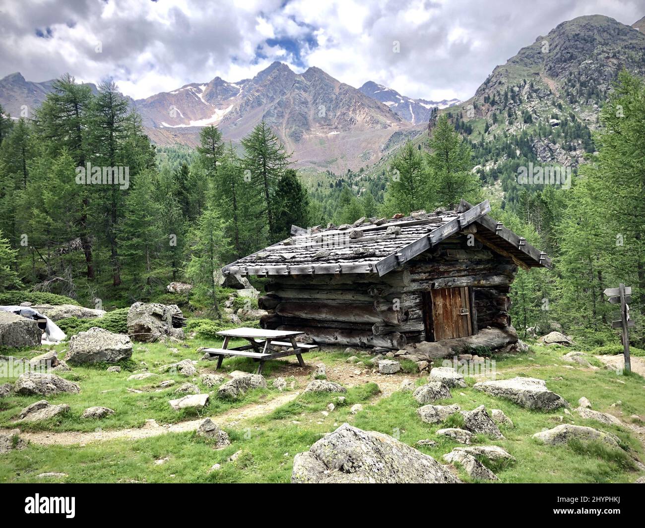 Beautiful shot of an old wooden cabin with a landscape on a background ...